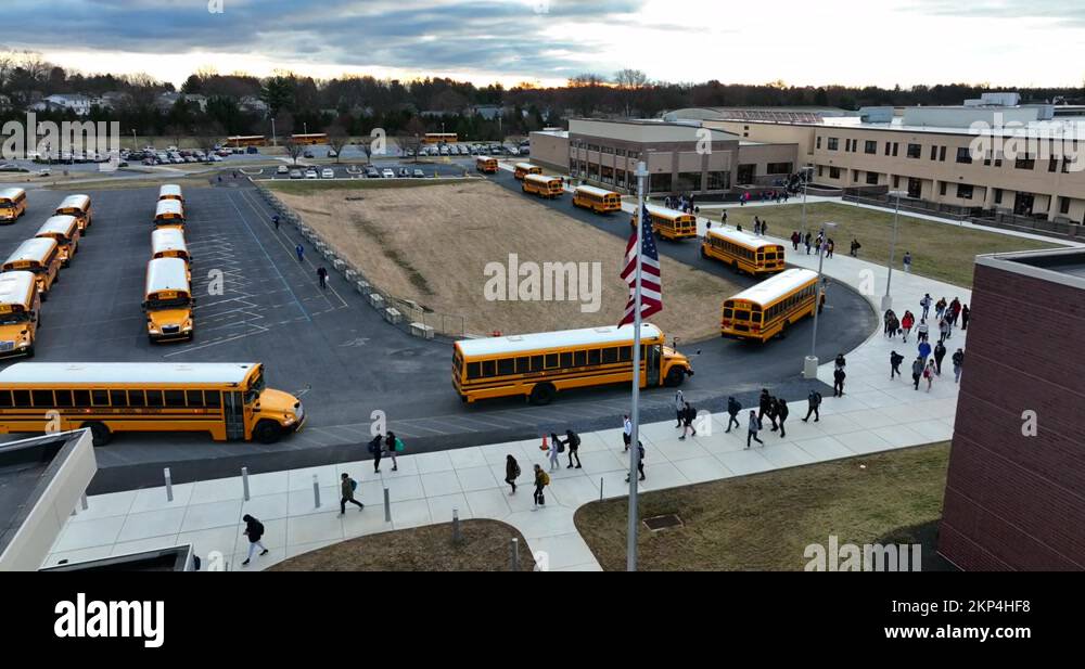 American school students arrive. School bus line up. Children and Stock ...