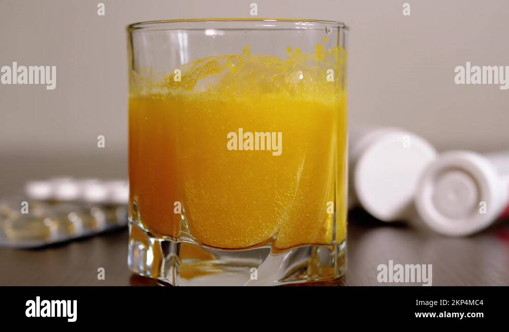 Effervescent Tablet Dissolves in a Glass of Water on the Background of ...
