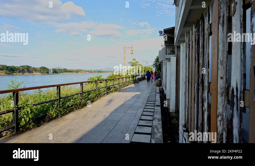 A time lapse of people walking up and down the paved walk at the ...