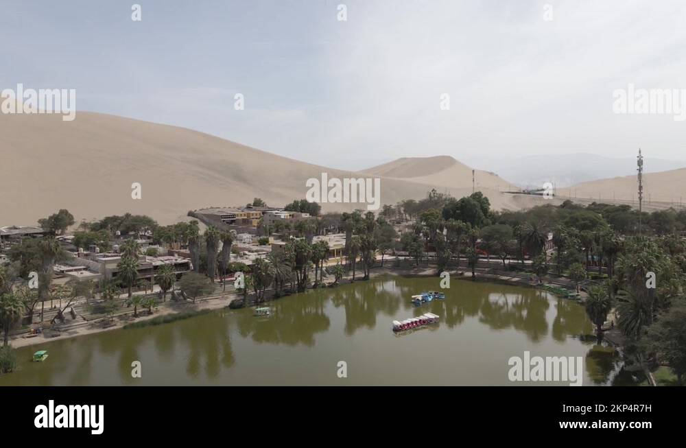 Long aerial ascent from Huacachina oasis reveals Ica Peru beyond Stock ...