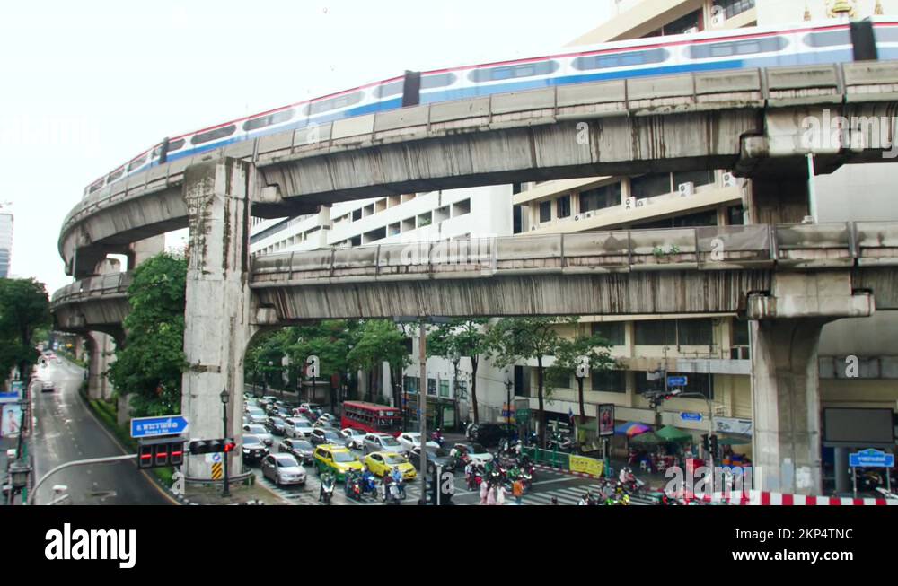 BTS Sky Train on rail tracks over traffic through busy intersections at ...