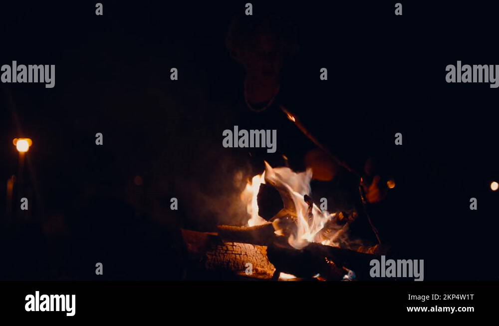 Man sitting by a campfire at night, fire, bonfire, looking at fire ...
