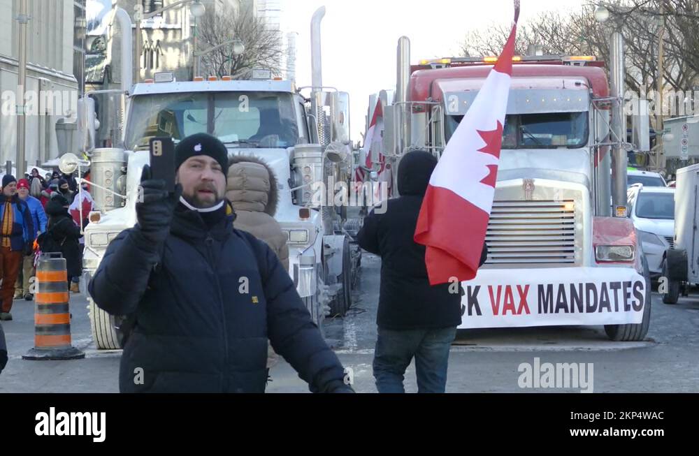 A group of people holding protests signs at the Freedom Convoy protest ...