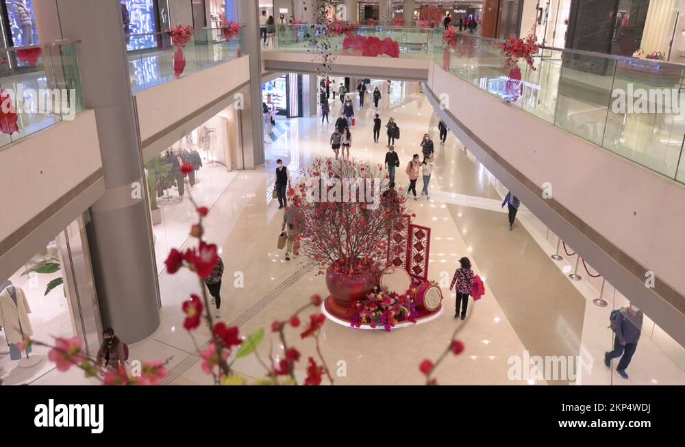People and shoppers are seen at a high-end luxury shopping mall in Hong ...