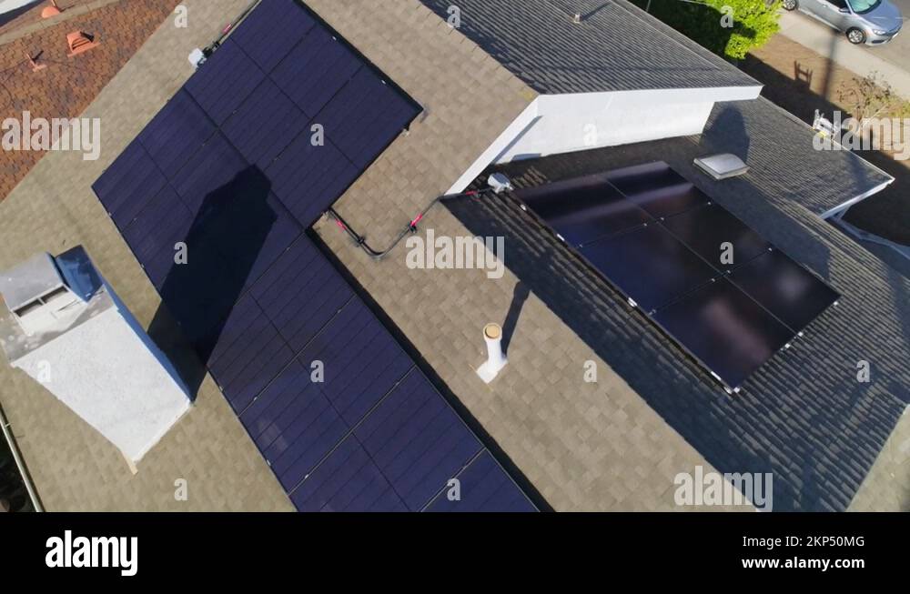 Slowly flying backward over an entire house rooftop with solar panels ...