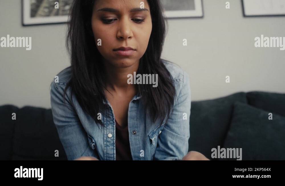 Tilt up video of broken mixed race woman holding an ultrasound scan and ...