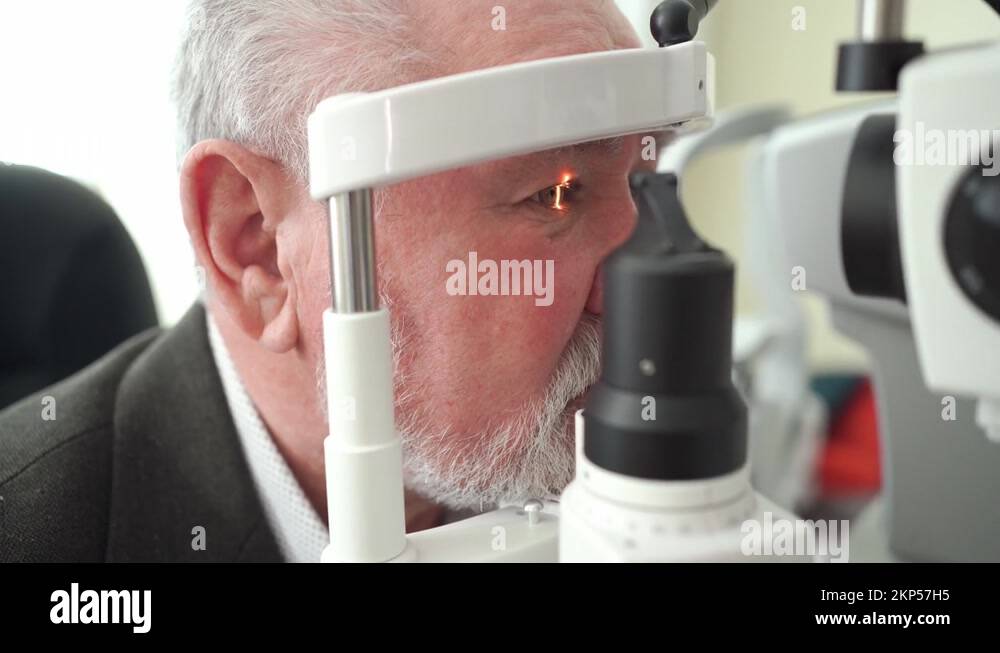 examination of elderly man with slit lamp. equipping ophthalmologist's ...