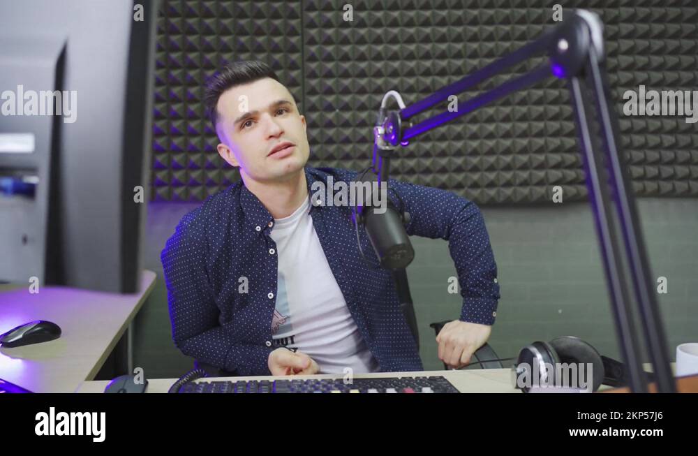 a male radio host conducts a live broadcast in a professional radio ...