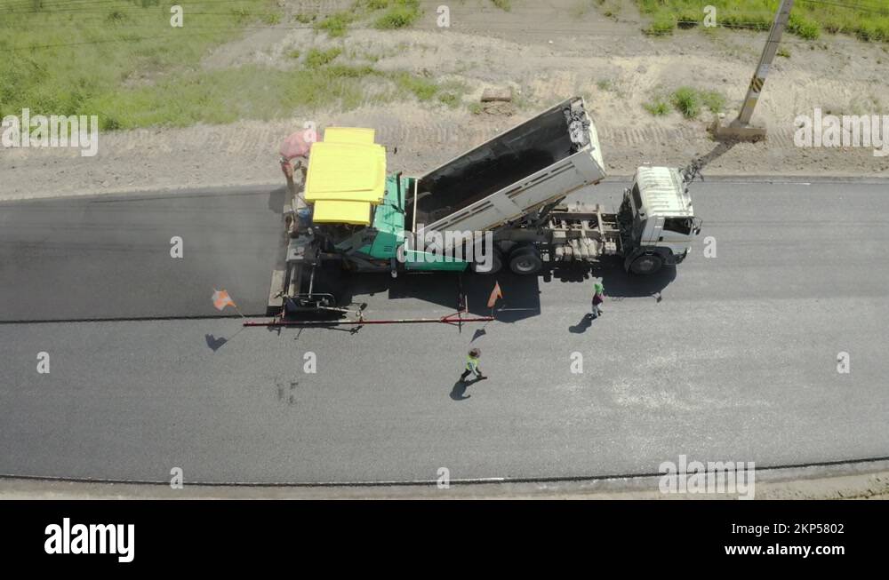 Road work. Large machine work on a new road construction site Stock ...