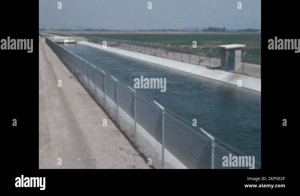 1960s: Dam. Water flows through canal. Body of water. Water treatment ...