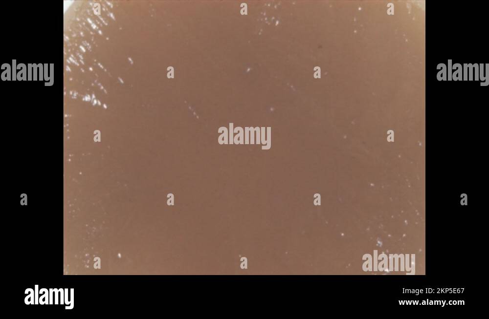 1960s: Liquid freezes. Person swirls materials around inside test tube ...