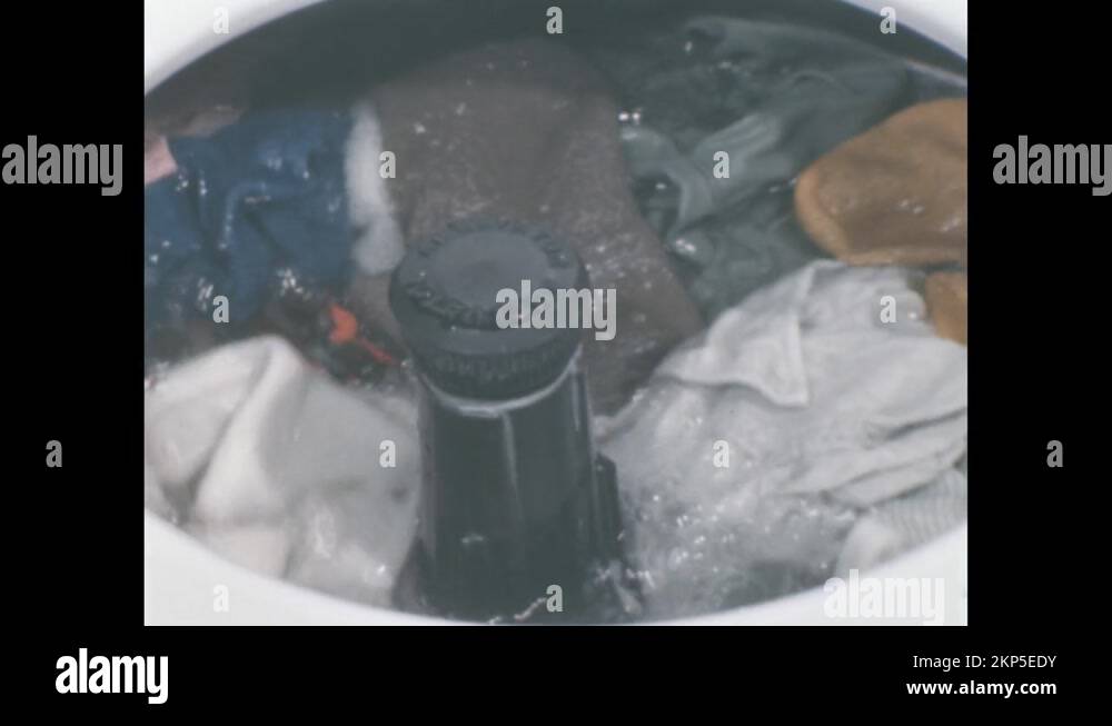 1960s: Clothes in a washing machine. Crop being irrigated Stock Video ...