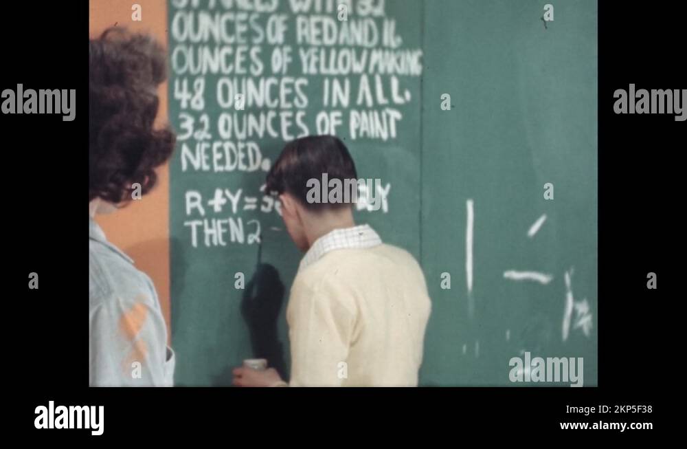 1950s: kneeling boy dips brush in paint jar and paints math equations ...