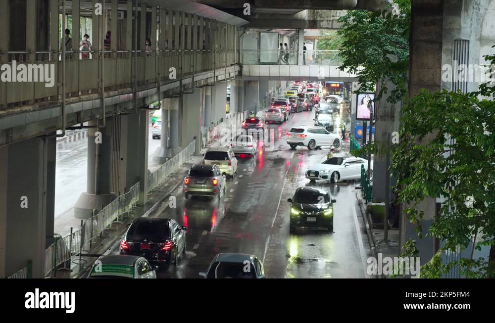 People walking on the skywalk above Traffic through busy intersections ...