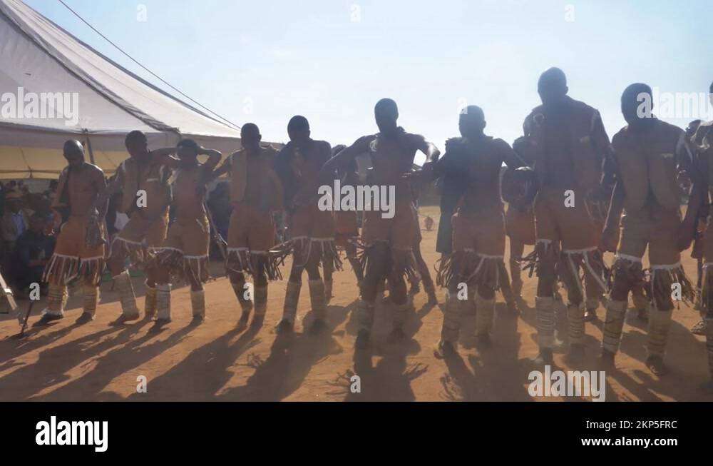 A group of Basarwa tribesmen performing in traditional attire, slow ...