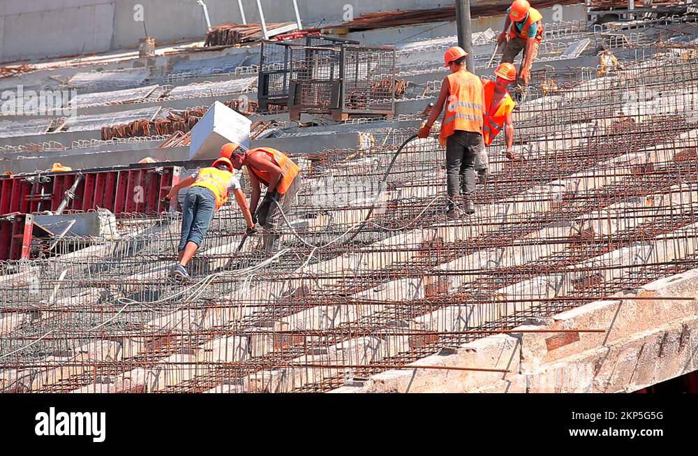 Workers make a reinforced concrete structure. Reinforced concrete ...