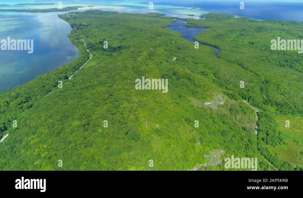 Flying high looking over tropical jungles and rivers of Peleliu island ...