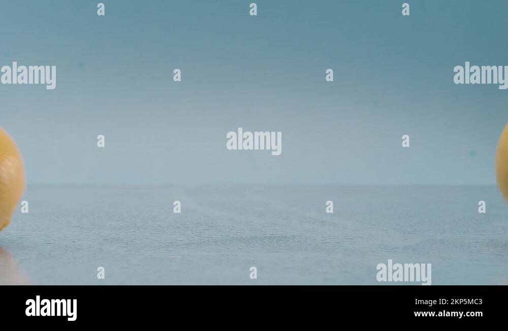 Slow Motion a Lemon Slice fall on blue background, Soft Drink with ...