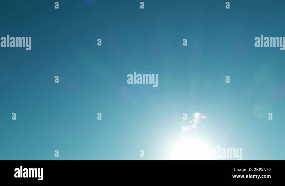 Bokeh sun light ray n rainbow spectrum lens flare on cyan blue sky ...