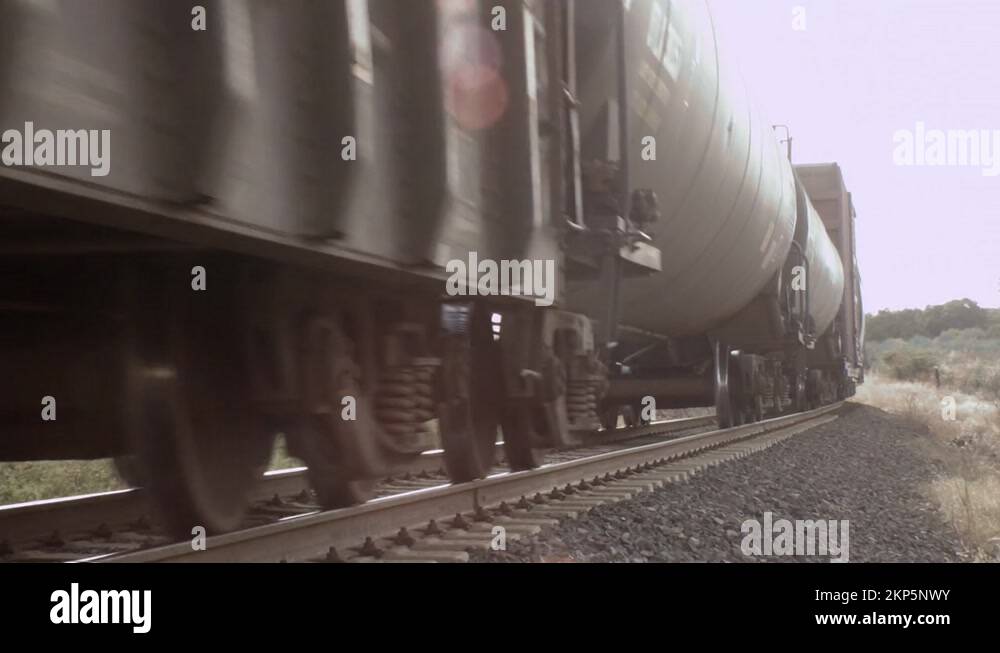 Train moving over railroad tracks alongside the country Stock Video ...