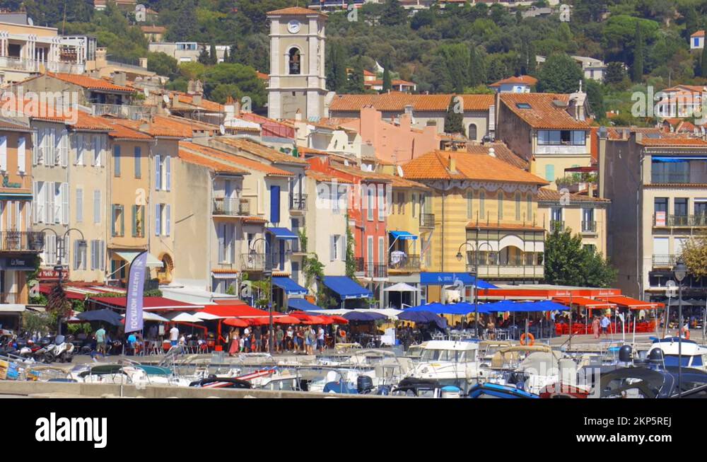 Colored buildings, terraces of restaurants and port of Cassis, France ...