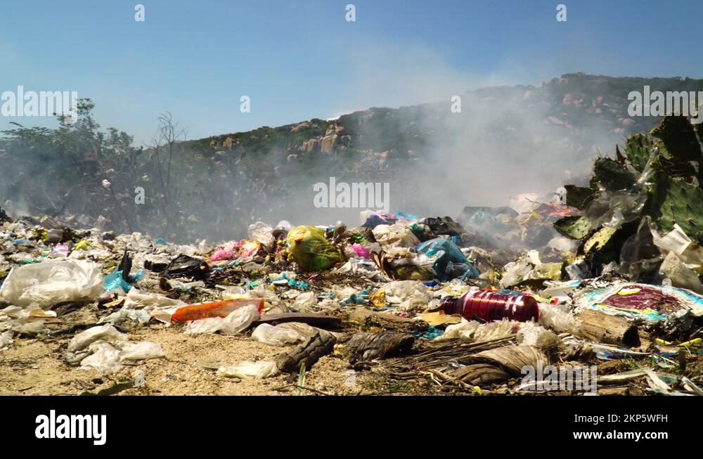 Pile of plastic waste in garbage dumb landfill, toxic smoke and fire ...