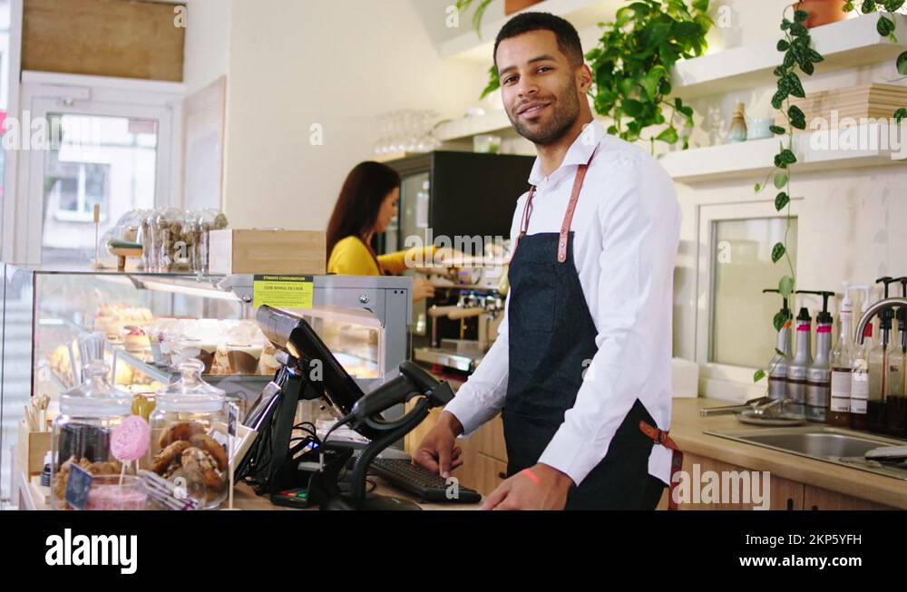 Charismatic Afro American guy in the coffee shop typing a order on the ...