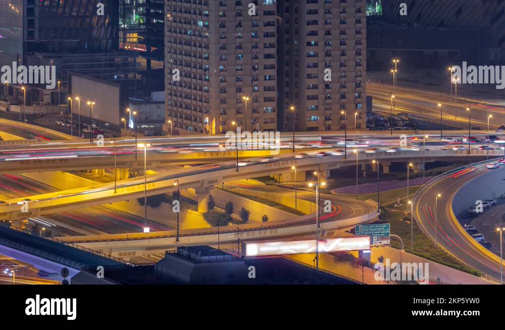 Big highway junction and Dubai water canal with pedestrian bridge over ...