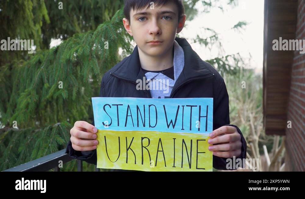 Poor boy kid homeless protesting armored conflict holding banner with ...