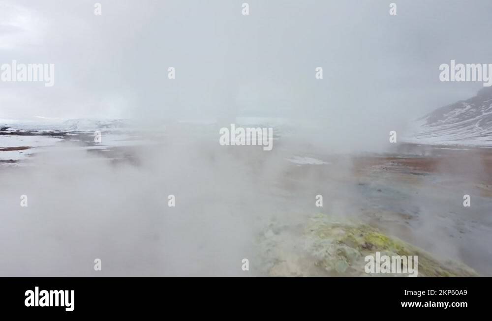 Magical dramatic scene with smoke from geothermal swamp and volcanoes ...