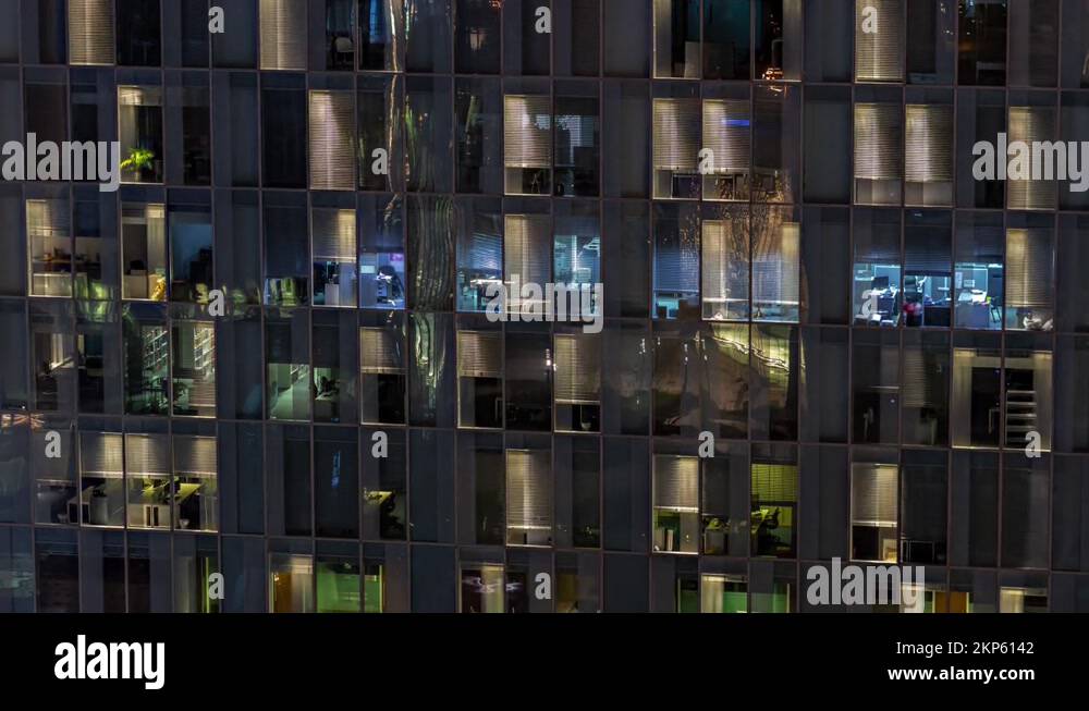 Night aerial view of office building glass window facade with ...