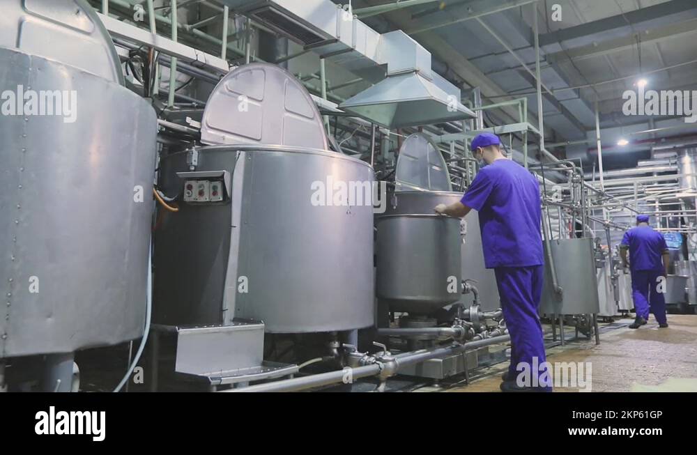 Working process in a food factory. Containers for liquids in a food ...