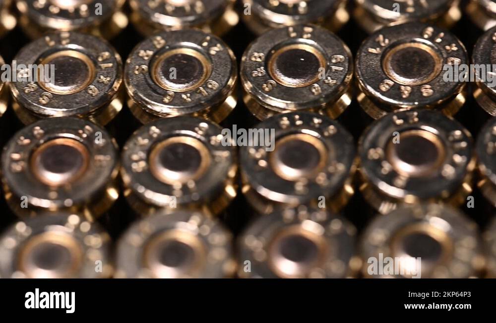 macro left to right slide over shiny new 9mm bullets Stock Video ...