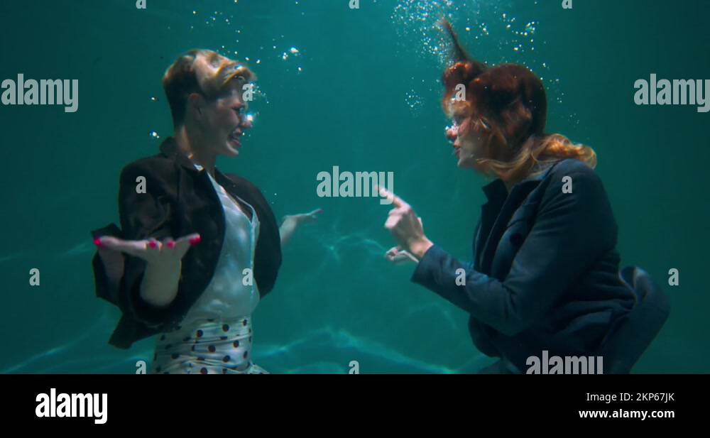 WORKPLACE CONFLICT Two young beautiful angry female office workers ...