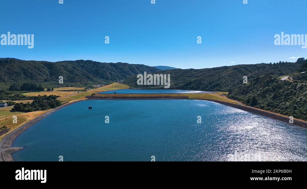 Reverse flight over sparkling blue lower lake of Te Marua - New Zealand ...