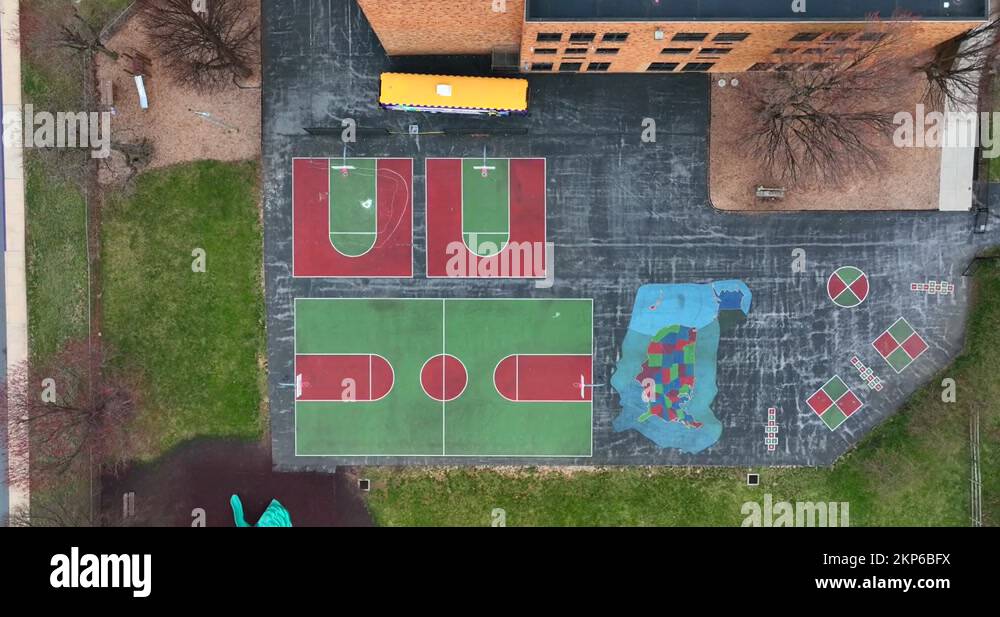 Top down aerial of school playground and school bus. Basketball court ...