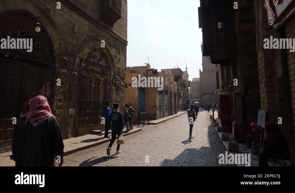 Egyptian people walking in pedestrian street of old Cairo historic town ...
