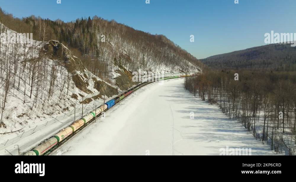 Freight long train carries with cargo carriages in hard to reach wild ...
