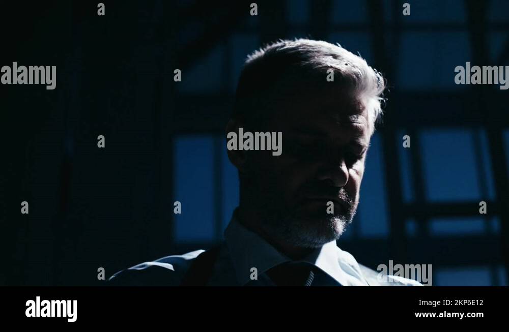 Intelligence officer drawing a gun, aiming it into the darkness ...