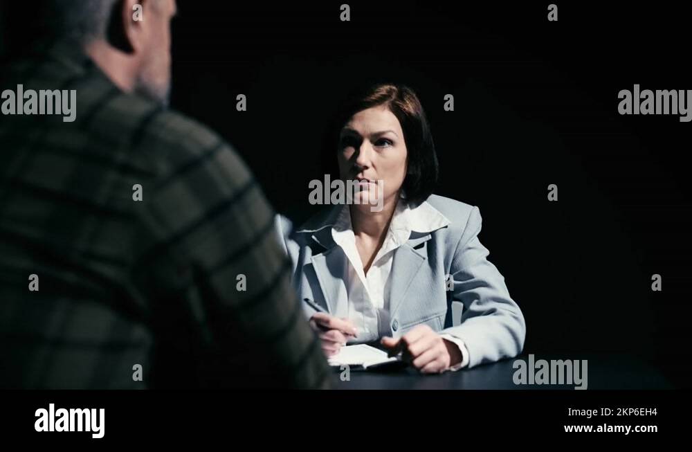 Female police detective questioning male suspect in custody ...