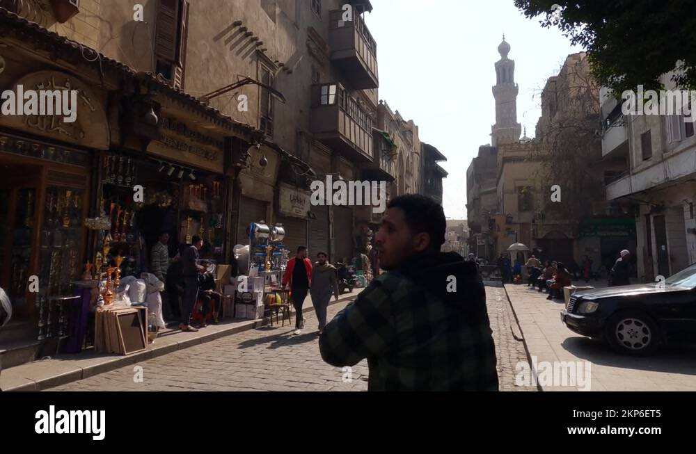 Busy Pedestrians crossing historic street in Islamic Cairo, Egypt ...