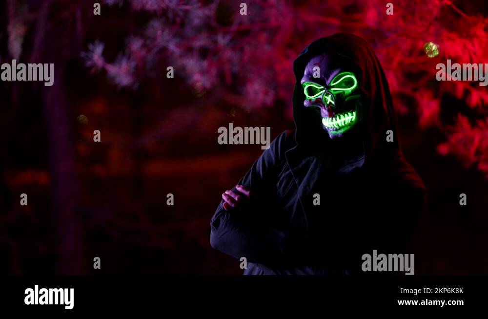portrait of a person in a terrible glowing mask of death and in a dark ...