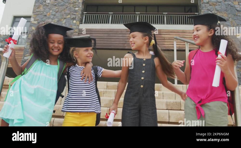 Video of happy diverse girls wearing graduation hats and holding ...