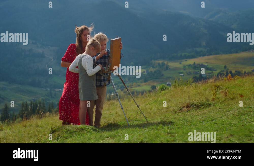 Talented family drawing picture outdoor. Painter teaching kids at ...