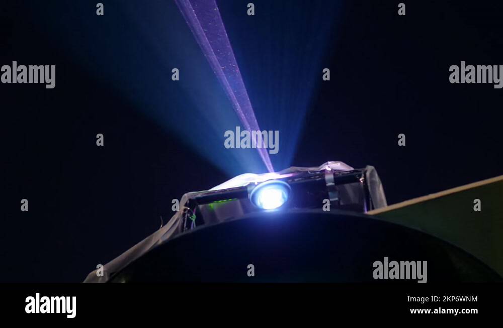A laser beam illuminates the night sky. Laser installation against the ...