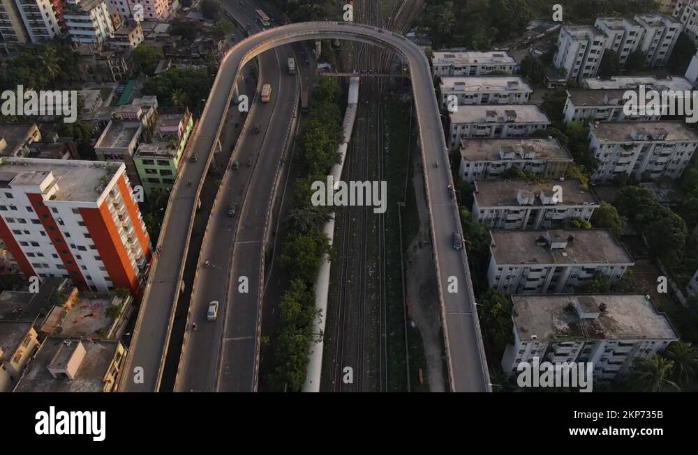 Highway loop flyover intersection with rail line between city building ...