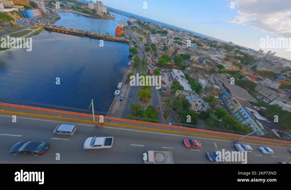 Drone flying over floating bridge and along Don Diego port, Santo ...
