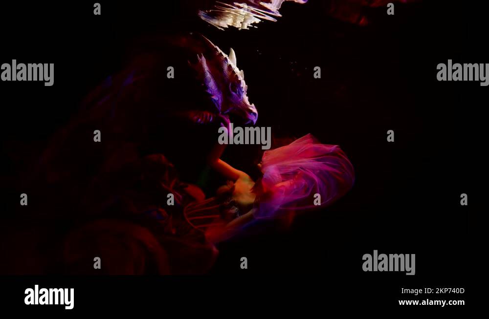 mystery of ocean, dragon and woman are floating in dark depth ...