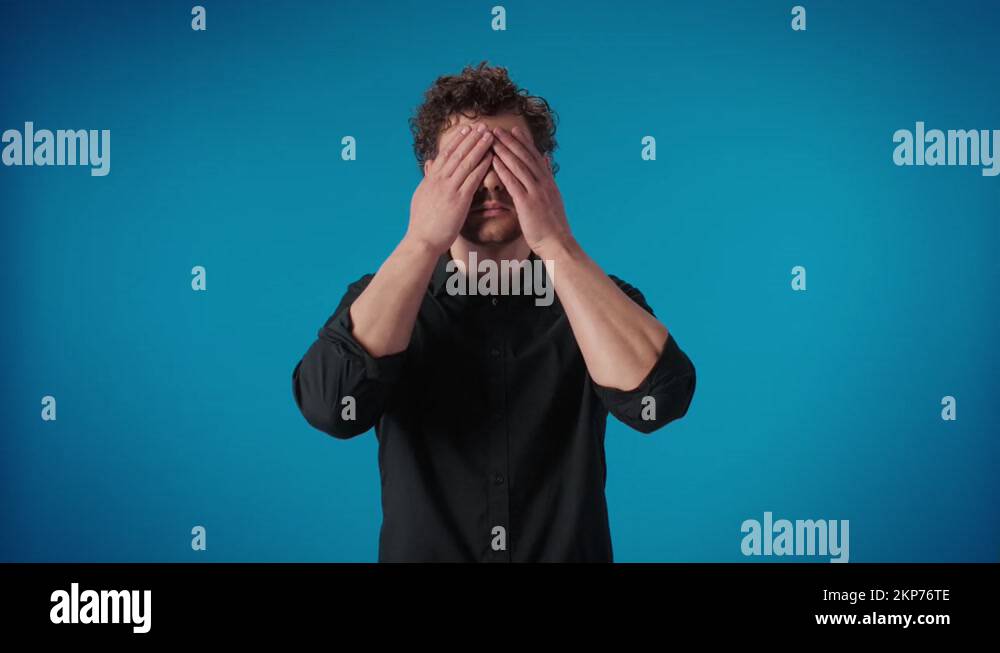 Portrait shocked male closed eyes by hands hiding having problem ...