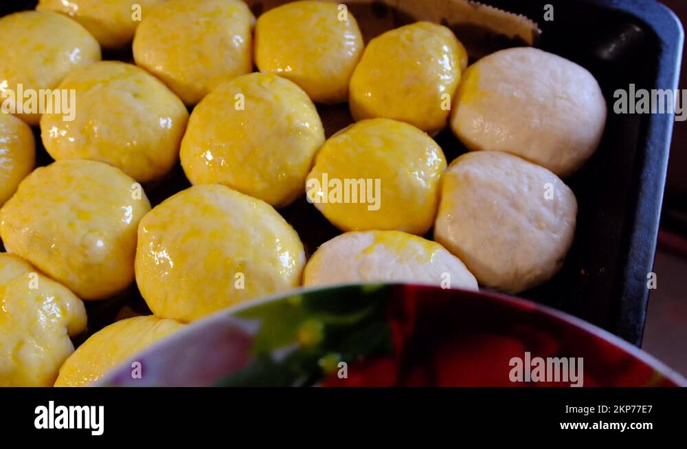 mother grease by egg a freshly apple pies in stove. Shot from right ...